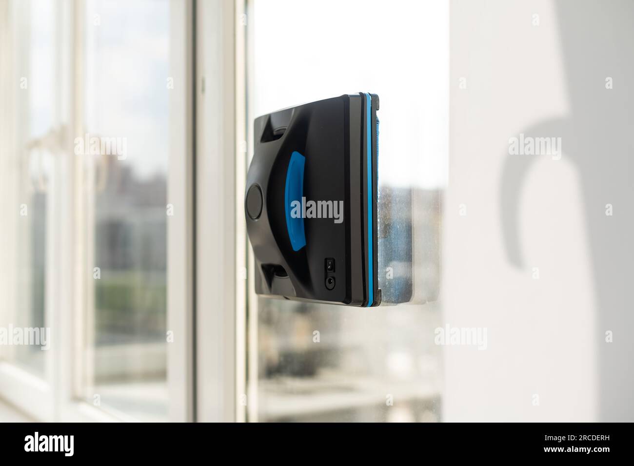 Modern window washer robot performs work on a dirty window. Cleaning ...