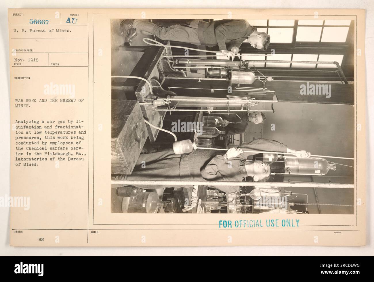 Employees of the Chemical Warfare Service are seen analyzing war gas by ...