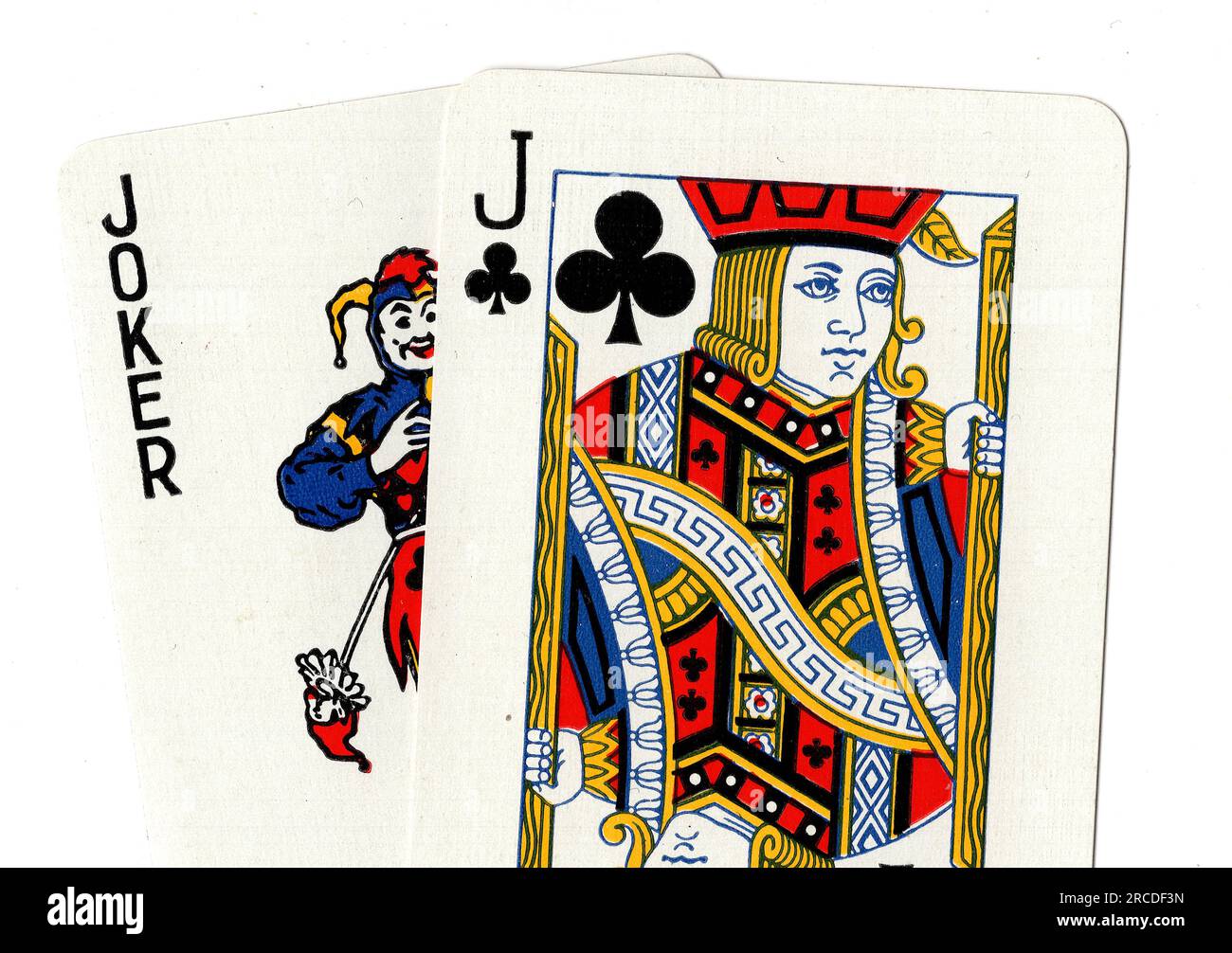 Vintage playing cards showing a joker and a jack of clubs on a white ...
