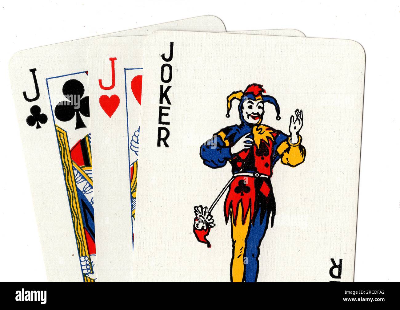 Vintage playing cards showing a joker and a pair of jacks on a white ...