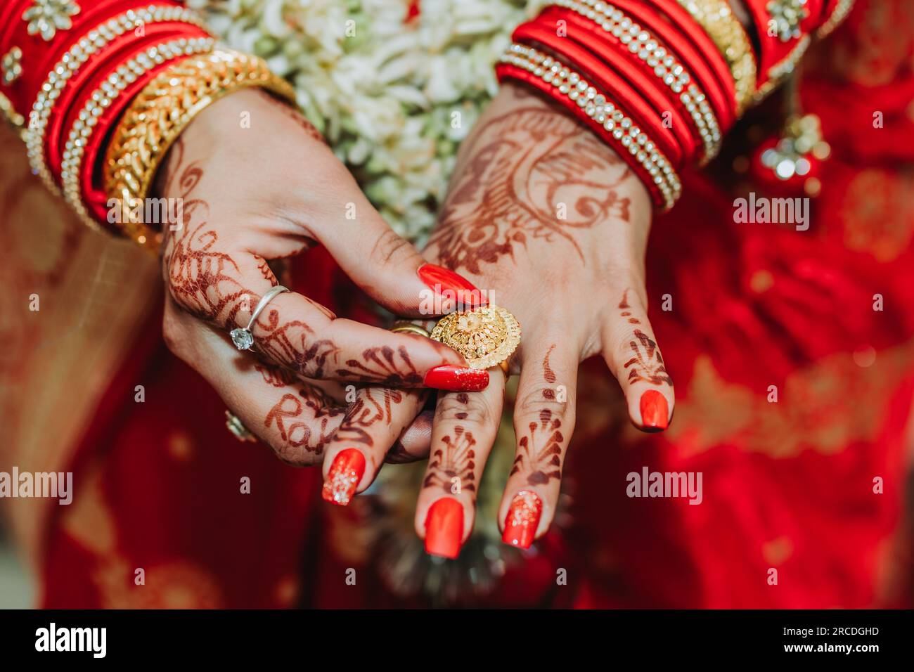 Bride Hands touching wedding ring, bride hands mehendi and bangles ...