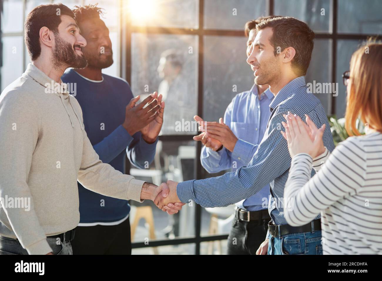 Smiling multiethnic friend getting acquainted in office corridor Stock ...