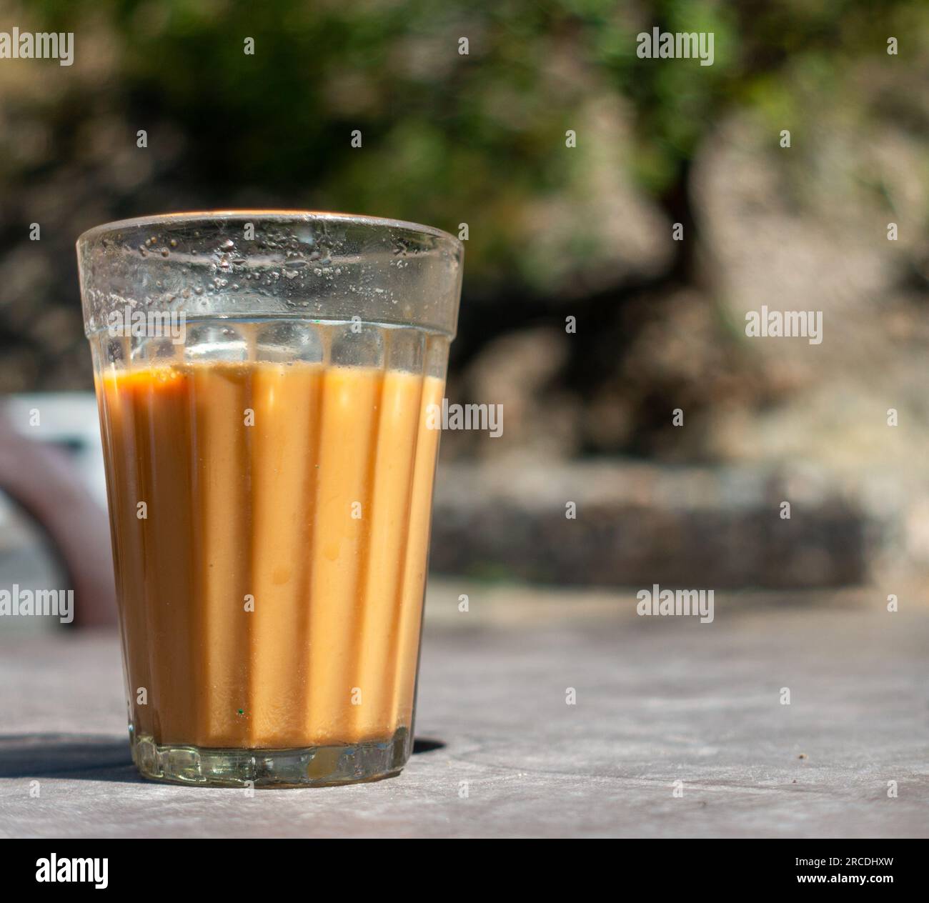 A close up shot of a milk tea in a traditional transparent glass. Road ...