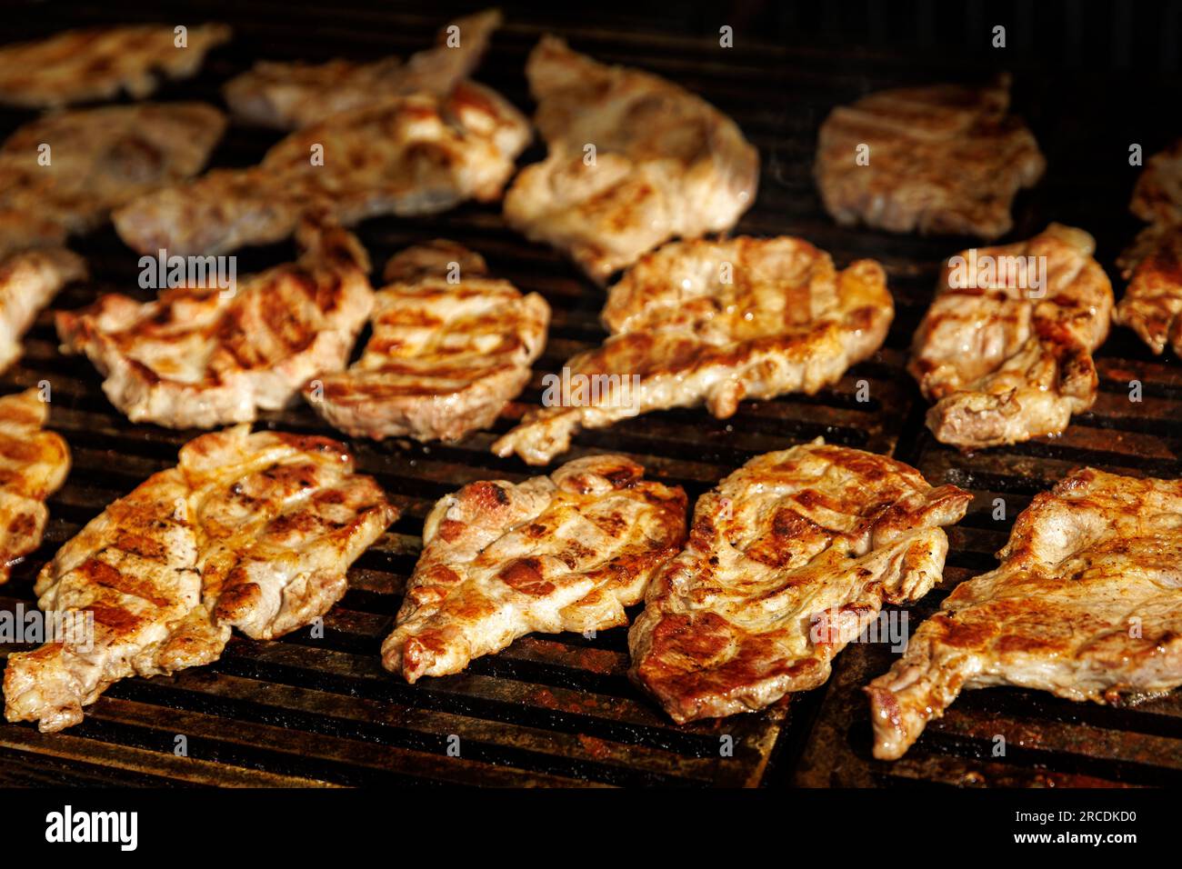 Pork meat are fried on fire, bbq grill service Stock Photo - Alamy