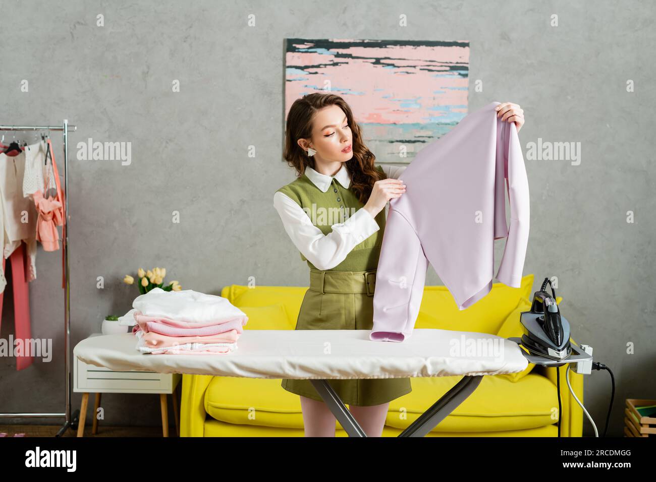 housekeeping concept, young woman with wavy hair holding clean ...