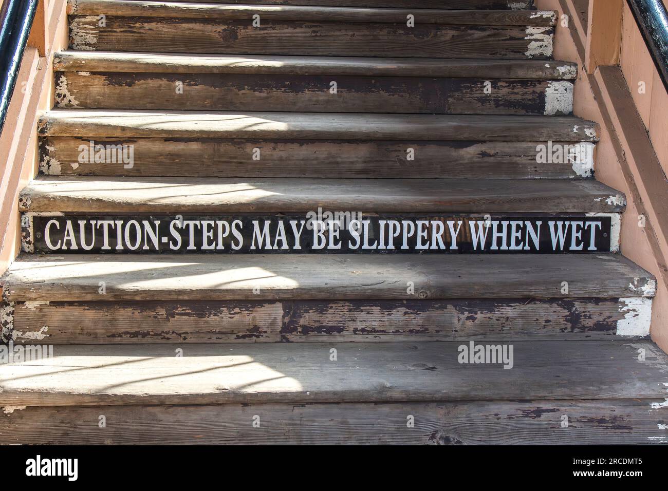Caution- steps slippery when wet sign on a wooden staircase Stock Photo ...