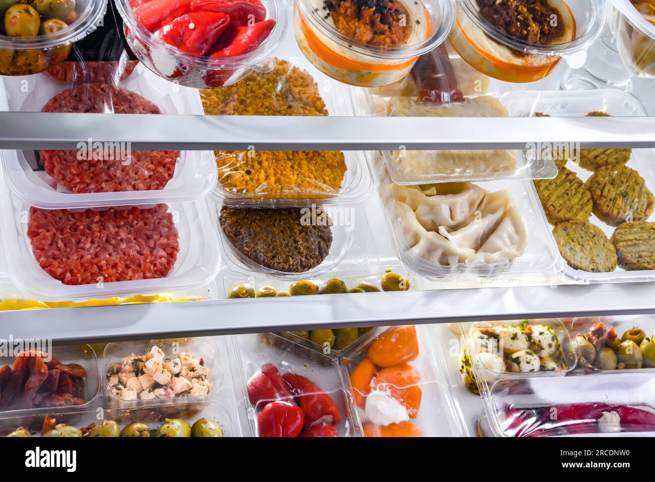 A display of variety of prepackaged food products in plastic boxes ...