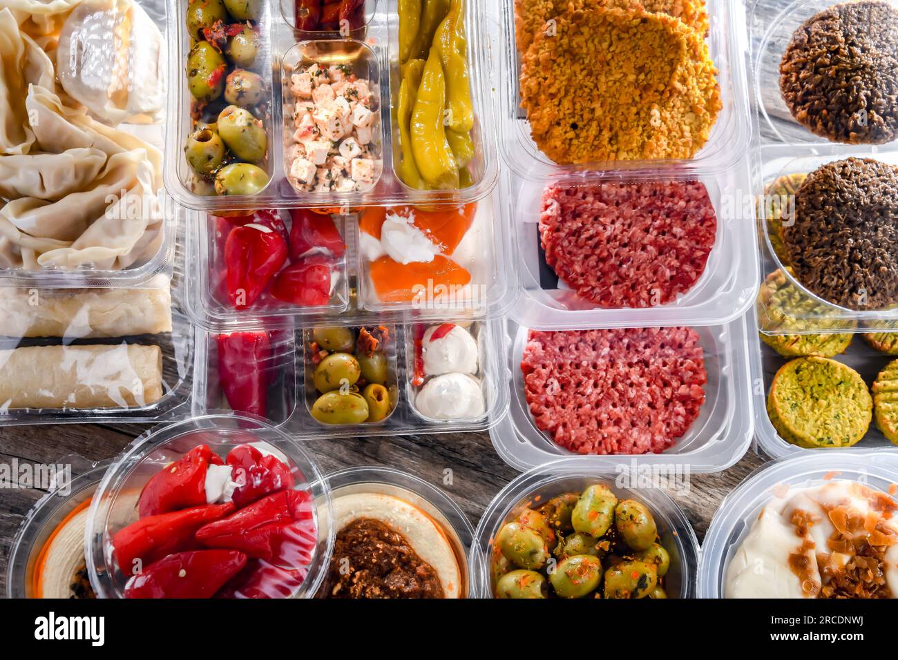 A display of variety of prepackaged food products in plastic boxes ...
