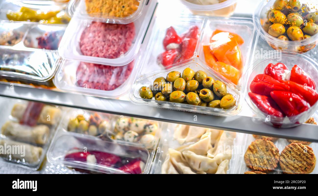 A display of variety of prepackaged food products in plastic boxes ...