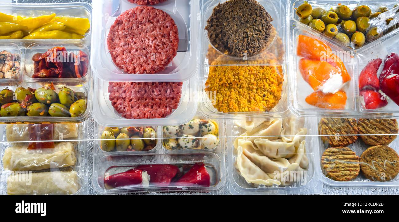 A display of variety of prepackaged food products in plastic boxes ...