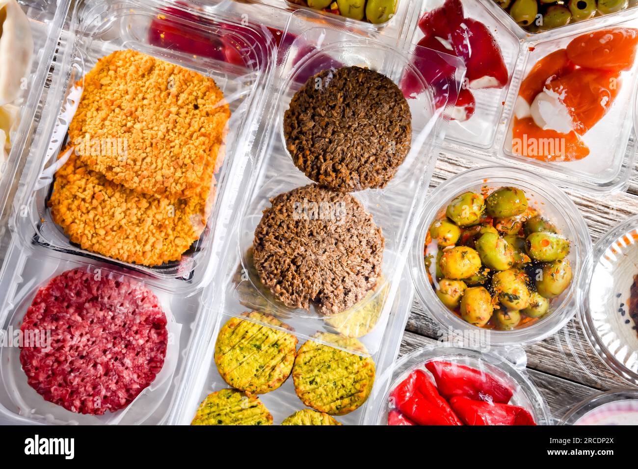 A display of variety of prepackaged food products in plastic boxes ...