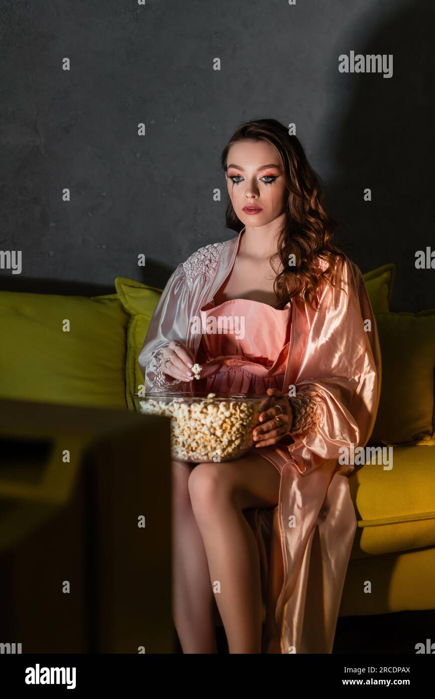 depression, sad woman with smudged mascara sitting on yellow couch ...
