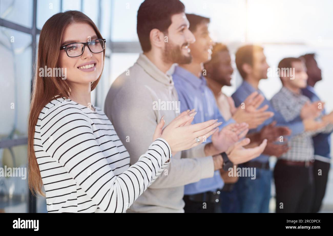 Side profile of business executives clapping in a row and smiling Stock ...