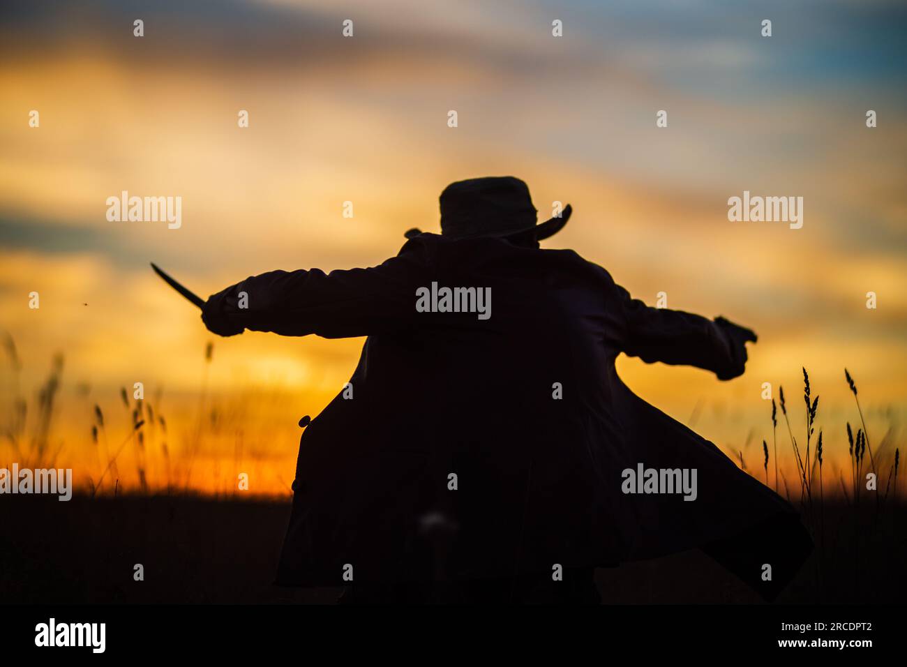 Demon and vampire hunter silhouette is fighting. A man with a katana ...