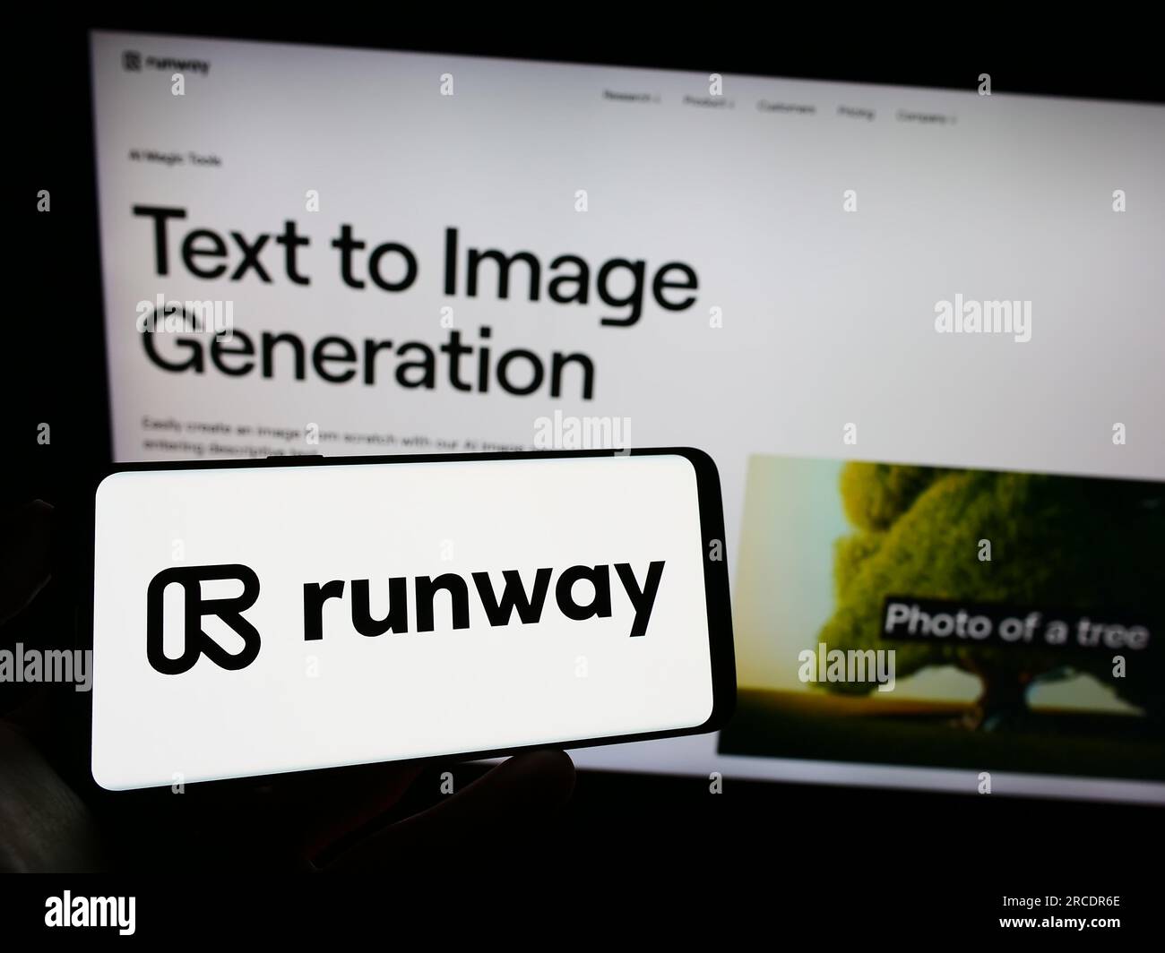 Person holding cellphone with logo of artificial intelligence company ...