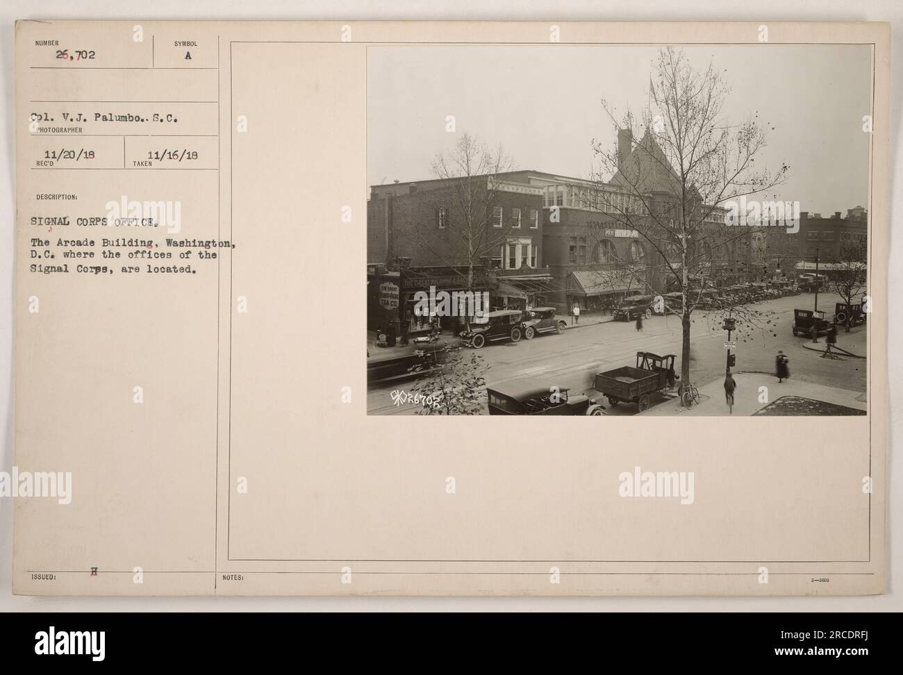 Cpl. V.J. Palumbo taking a photograph of the Arcade Building in ...