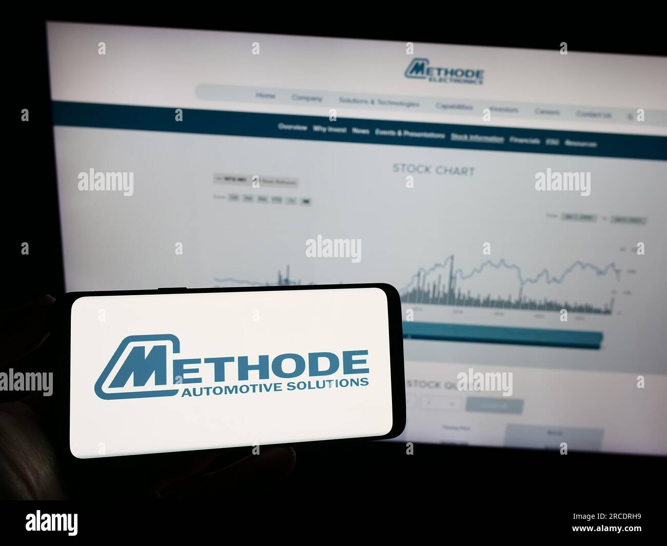 Person holding mobile phone with logo of American company Methode ...