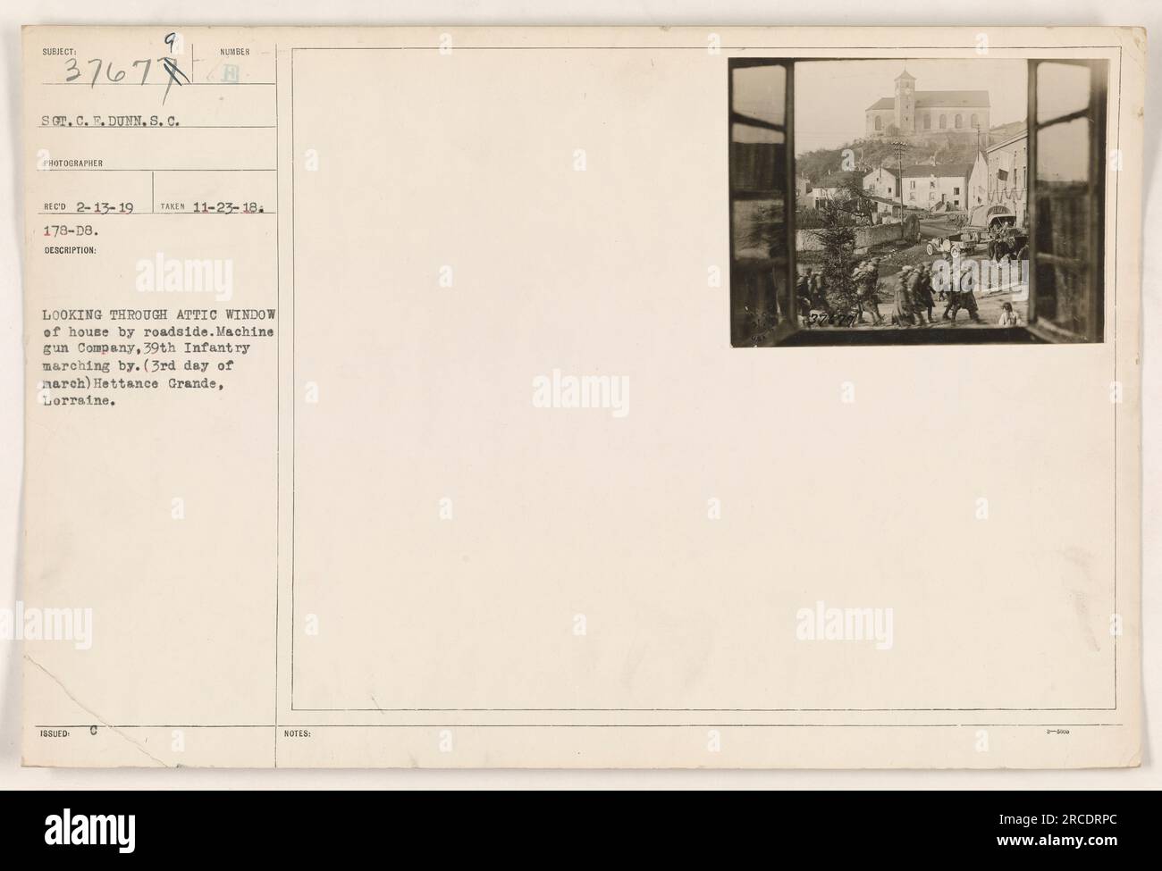 Caption: Machine Gun Company, 39th Infantry, marching past a house by ...