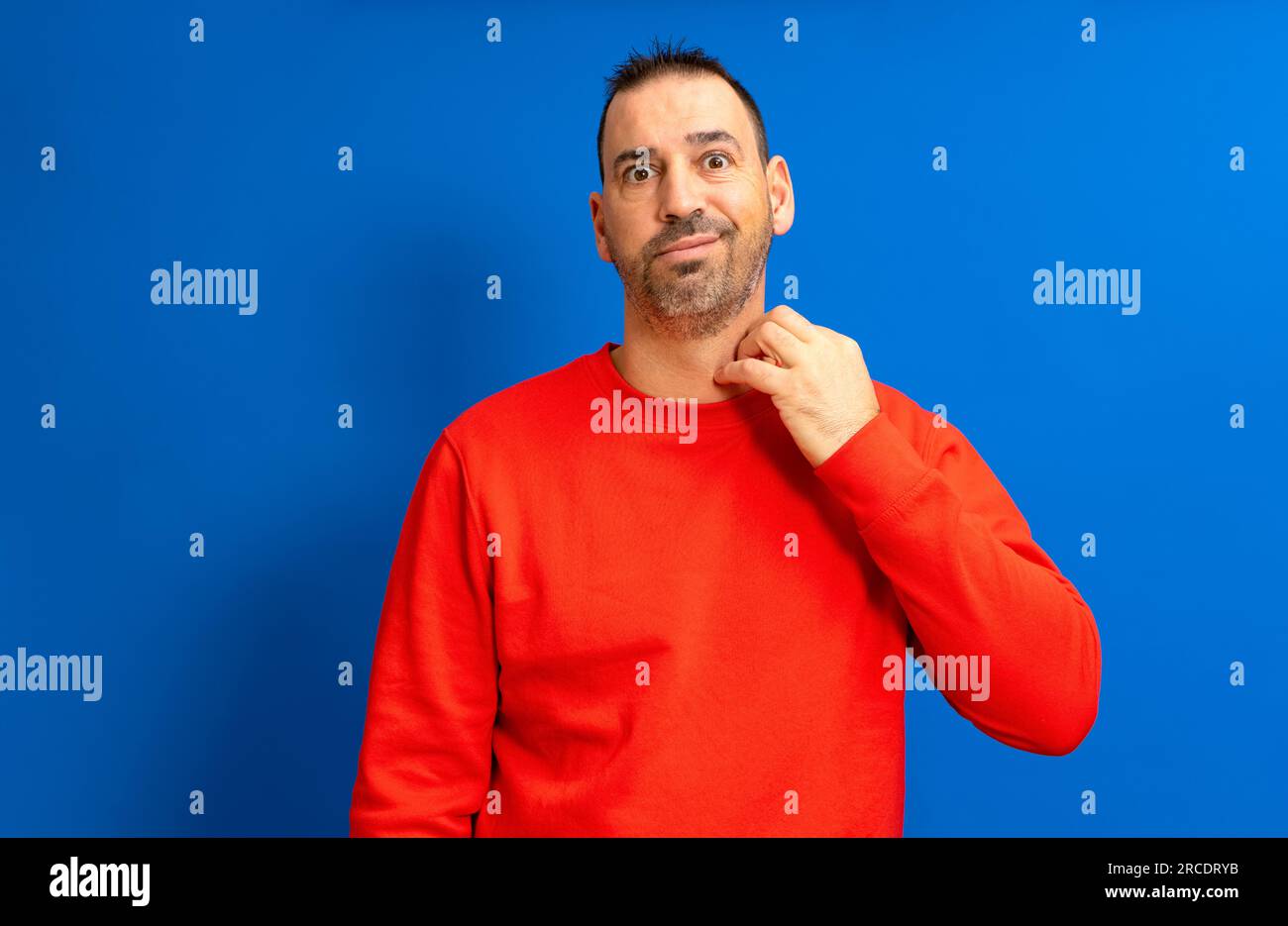 Middle age bearded man scratching himself highlighted with red collar ...