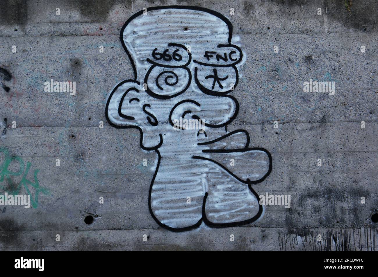 Graffiti with symbols on a concrete wall. Abstract human head. Ireland ...