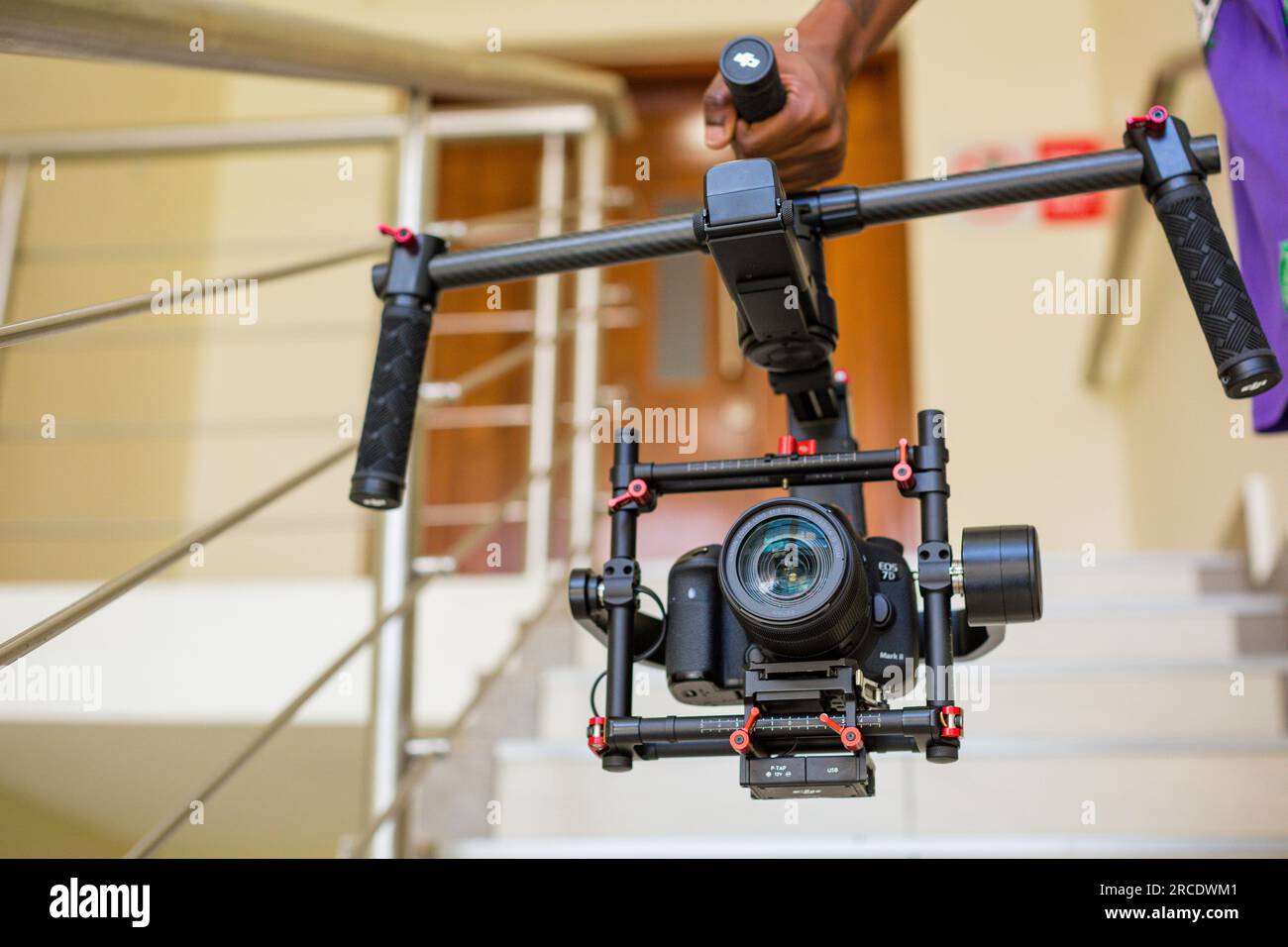 Hand Carrying gimbal camera stabilizer on stairs Stock Photo - Alamy