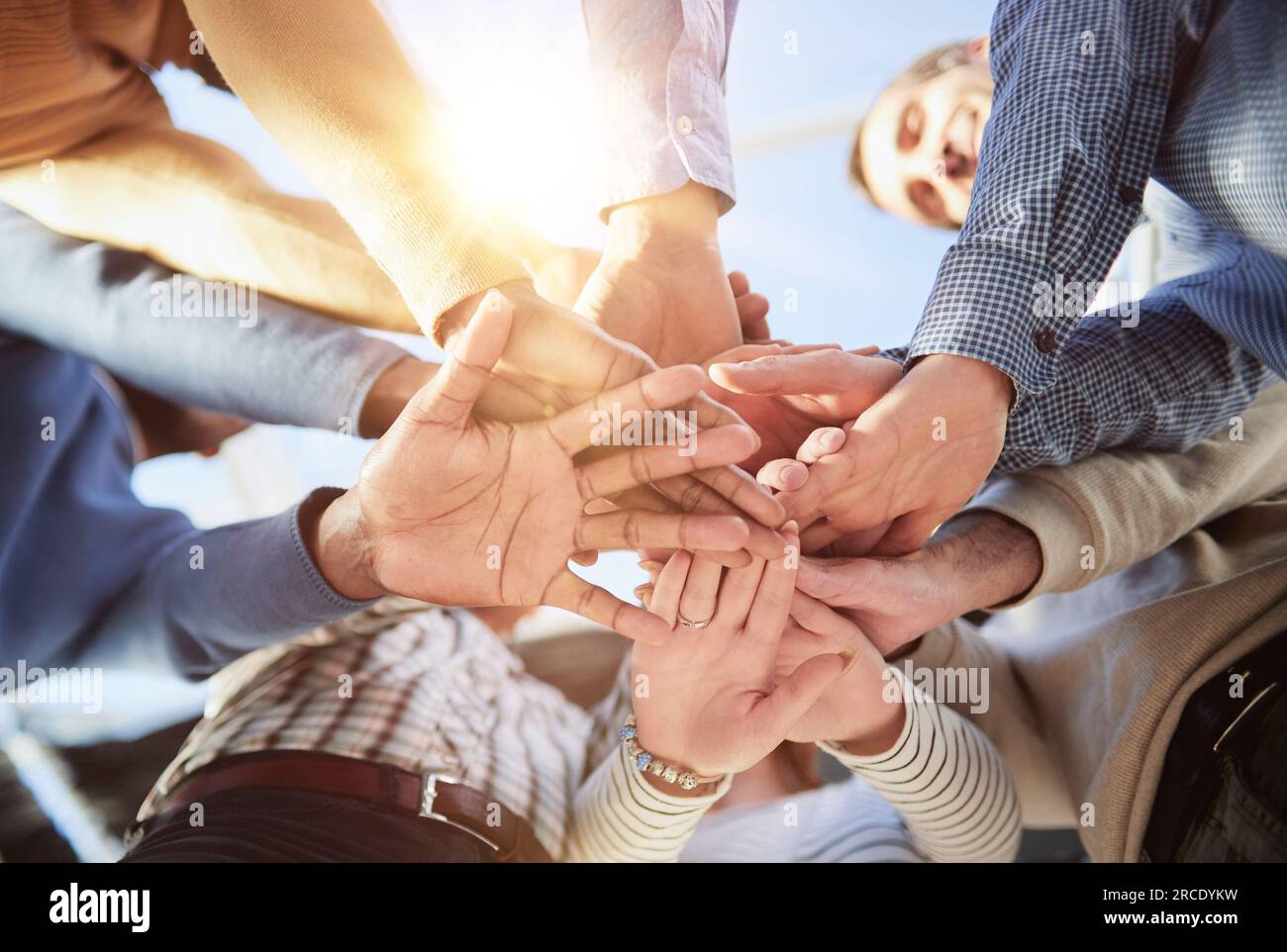 young business people putting their hands together. Stack of hands. Unity and teamwork concept ...