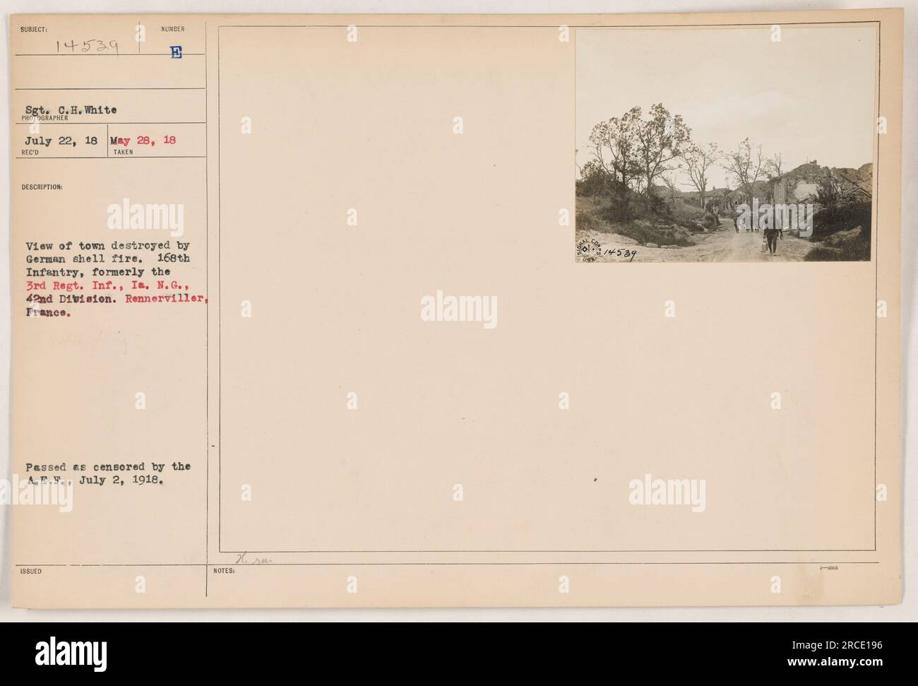 Soldiers survey the aftermath of a town destroyed by German shell fire ...