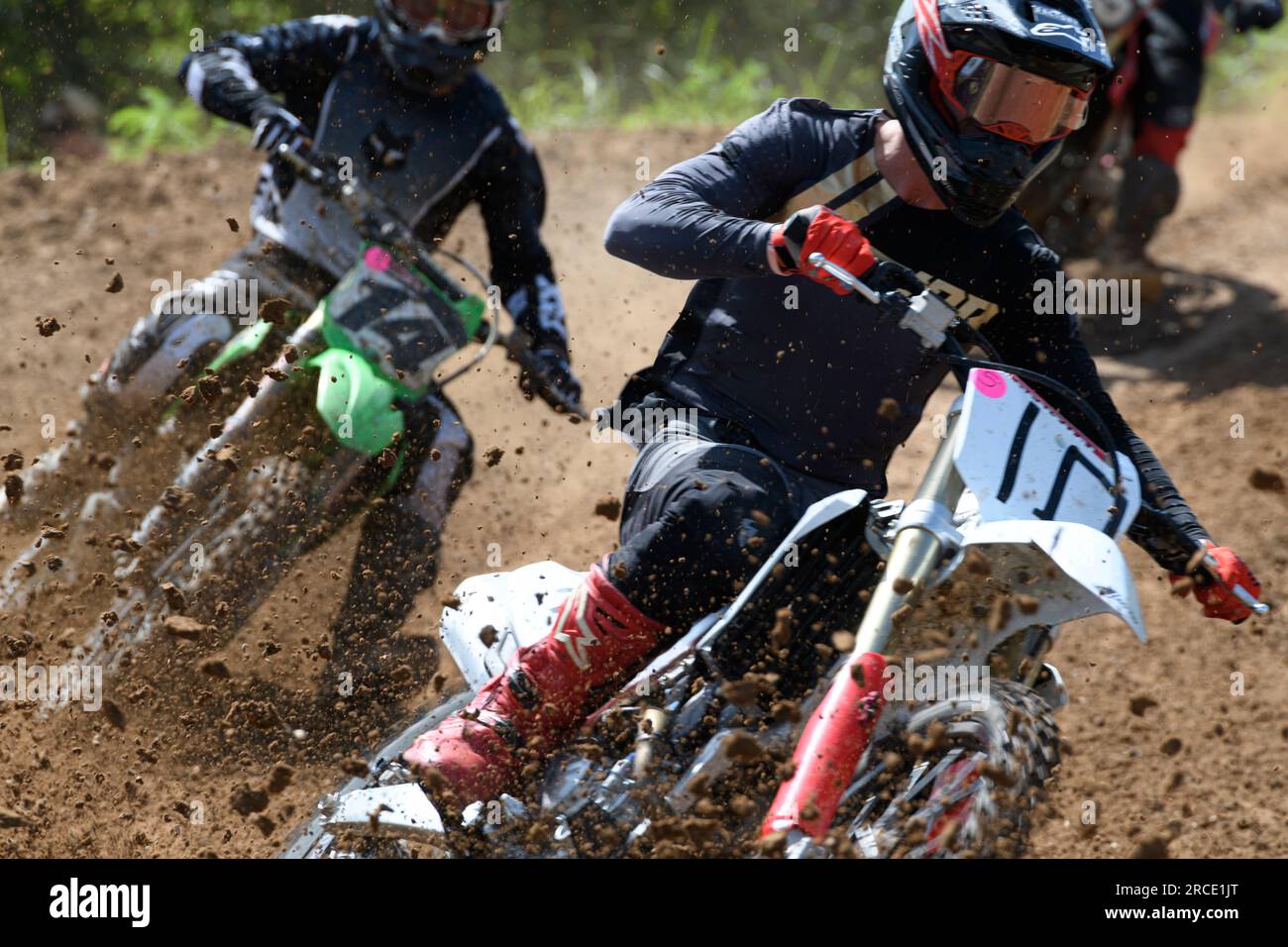 Motocross racers speed through the dirt holographically suspended in ...