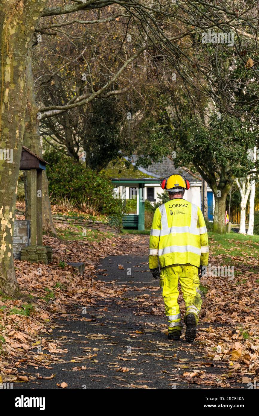 A Cormac construction worker wearing hi-viz workwear walking along an ...