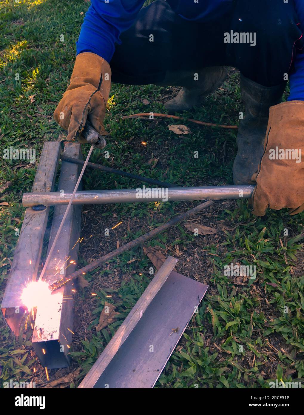 Hand of man welding steel, blurred on black background, Welder concept ...