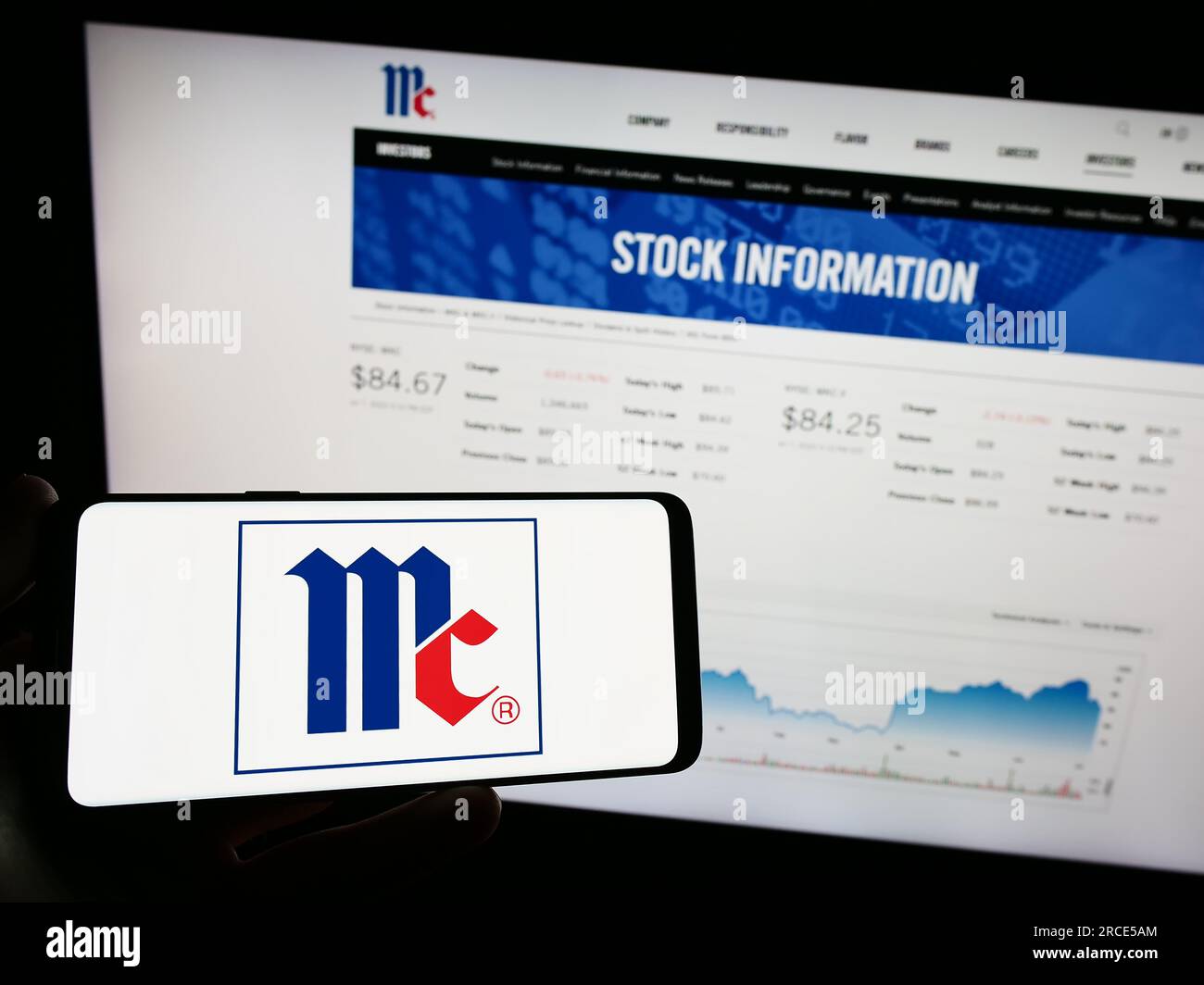 Person holding mobile phone with logo of American company McCormick ...