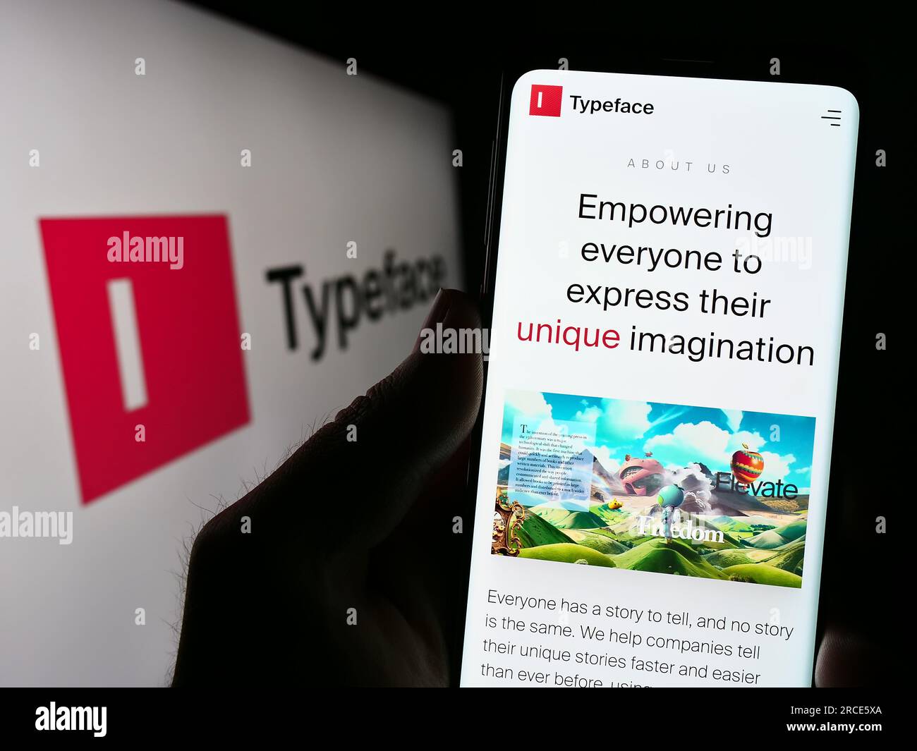 Person holding cellphone with website of US artificial intelligence company Typeface Inc. on ...