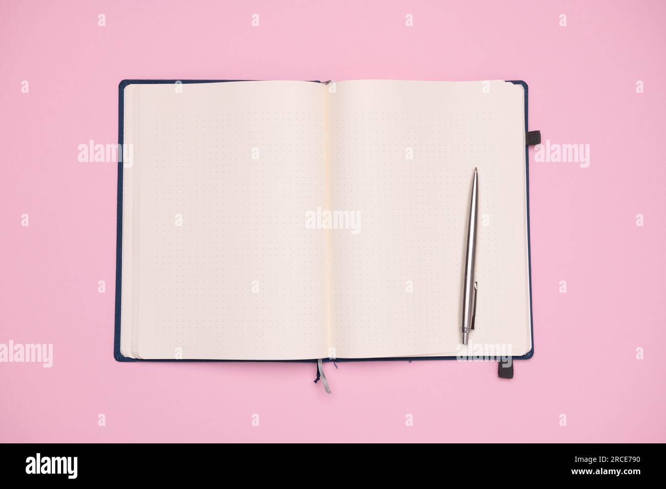 View from above. Blank pages of a notepad and stylish silver pen ...