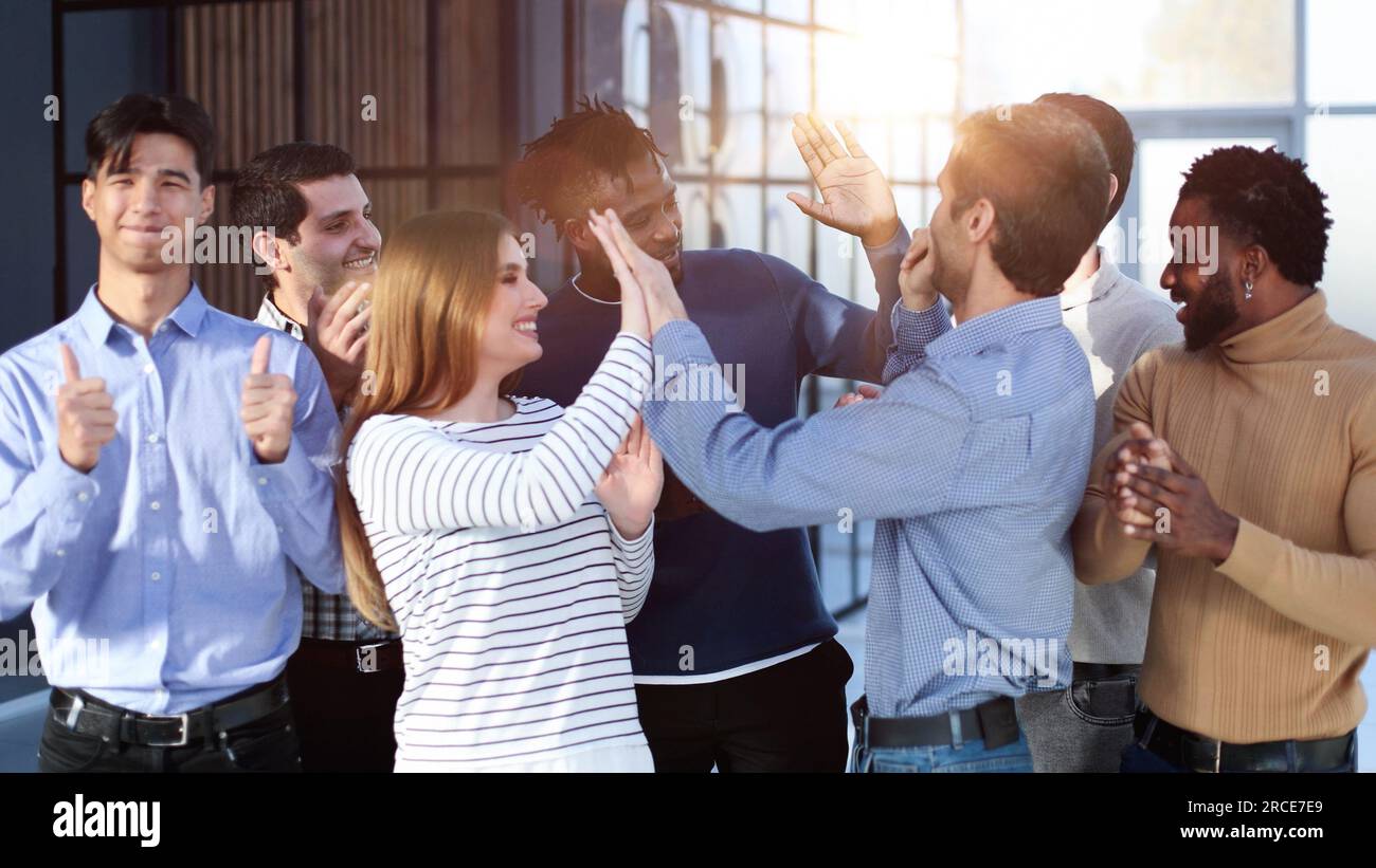 happy excited millennial employees shouting for joy, raising hands for ...