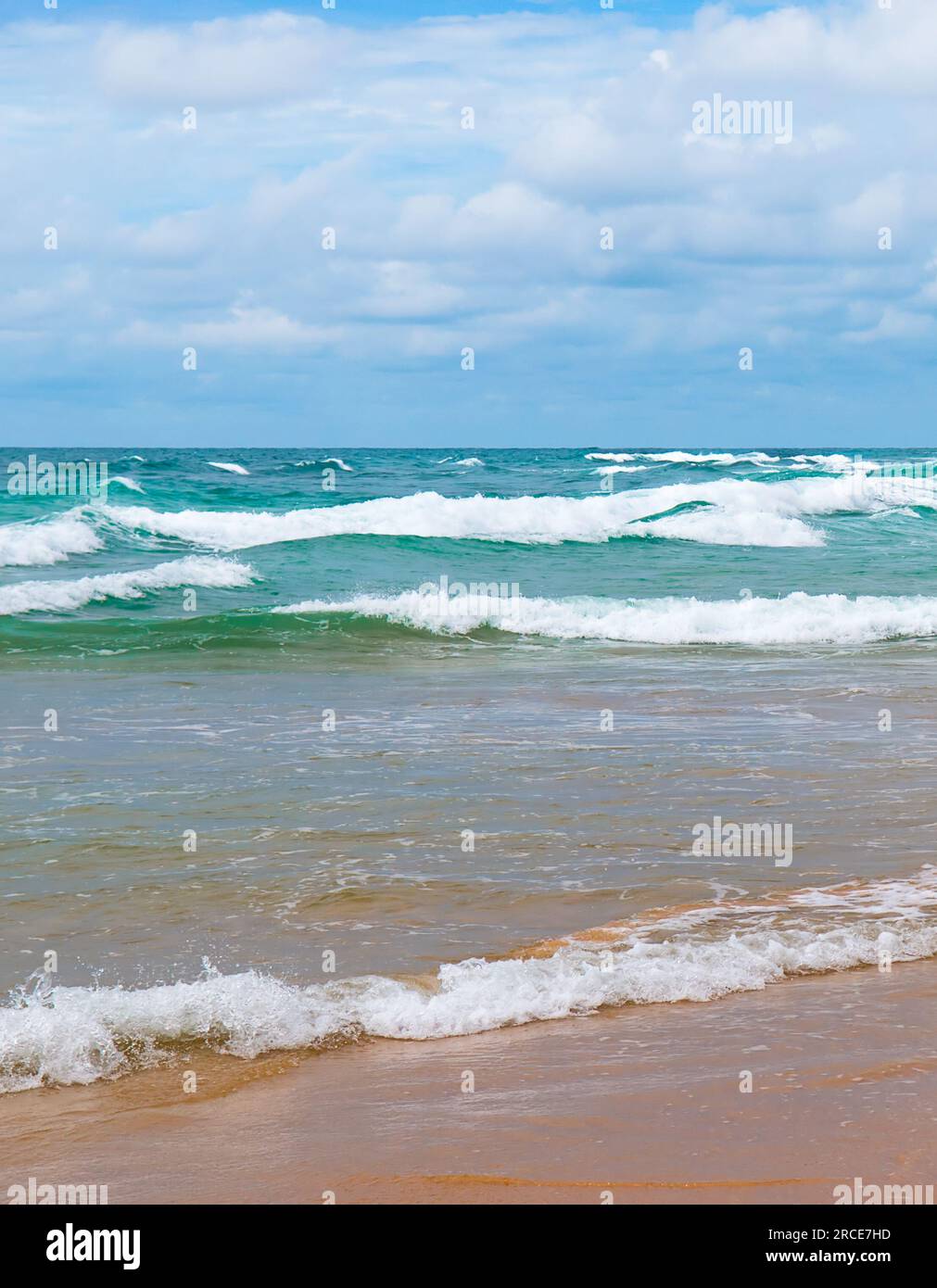 Tropical beach with high waves. Vertical photo Stock Photo - Alamy