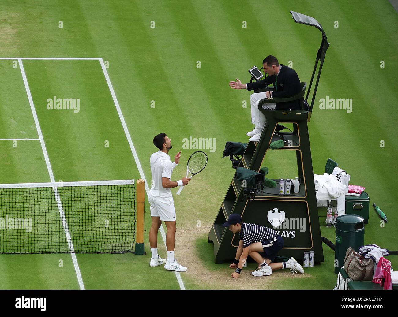 Novak Djokovic (left) talks with chair umpire Richard Haigh after a ...