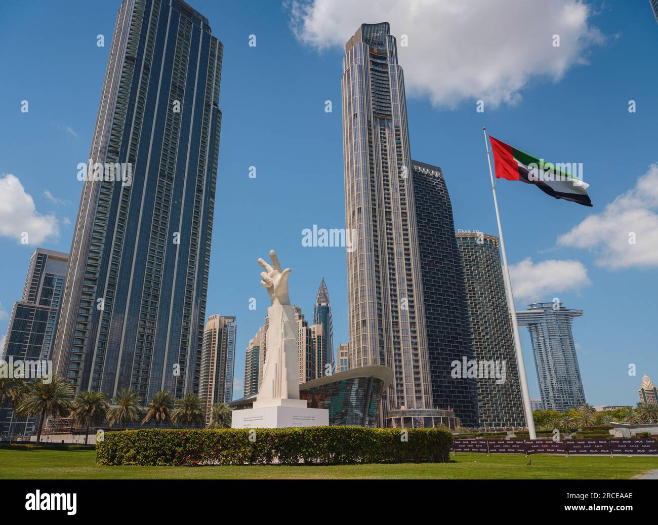 20 March 2023, Dubai, UAE: three fingers statue near UAE flag in sunny ...