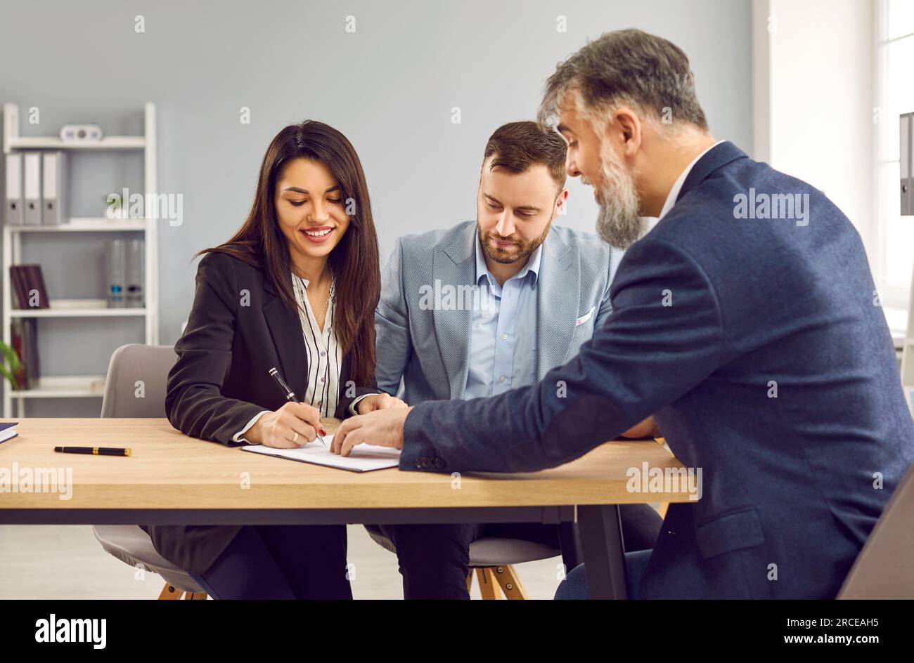 Happy insurance agent sitting hi-res stock photography and images - Alamy