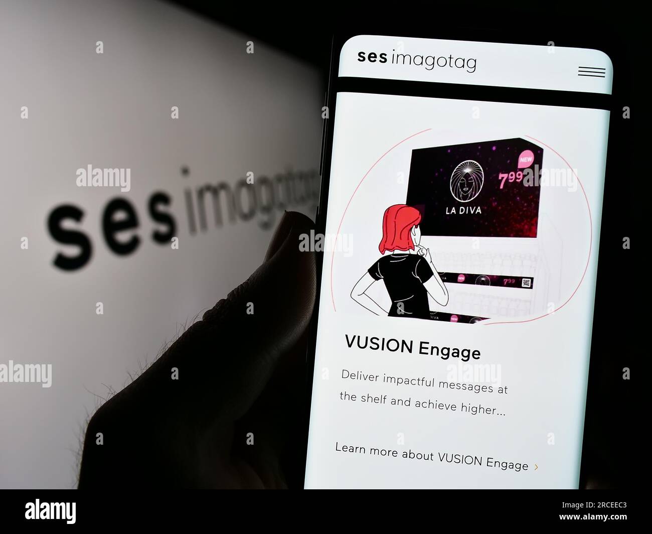 Person holding cellphone with webpage of French labeling company SES ...