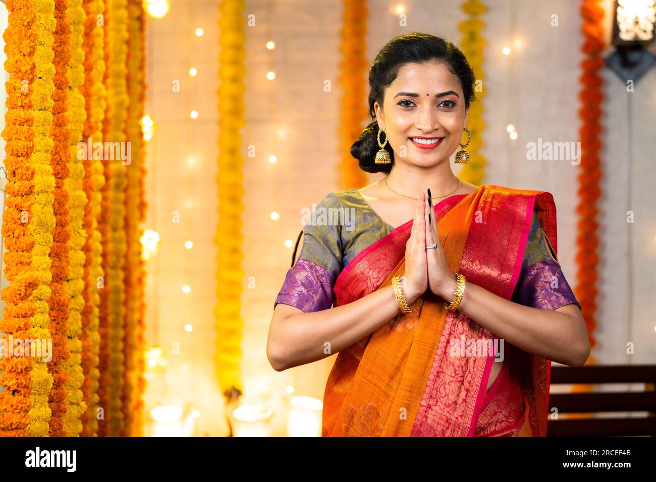 Happy indian girl with traditional ethnic dress showing namaste gesture ...