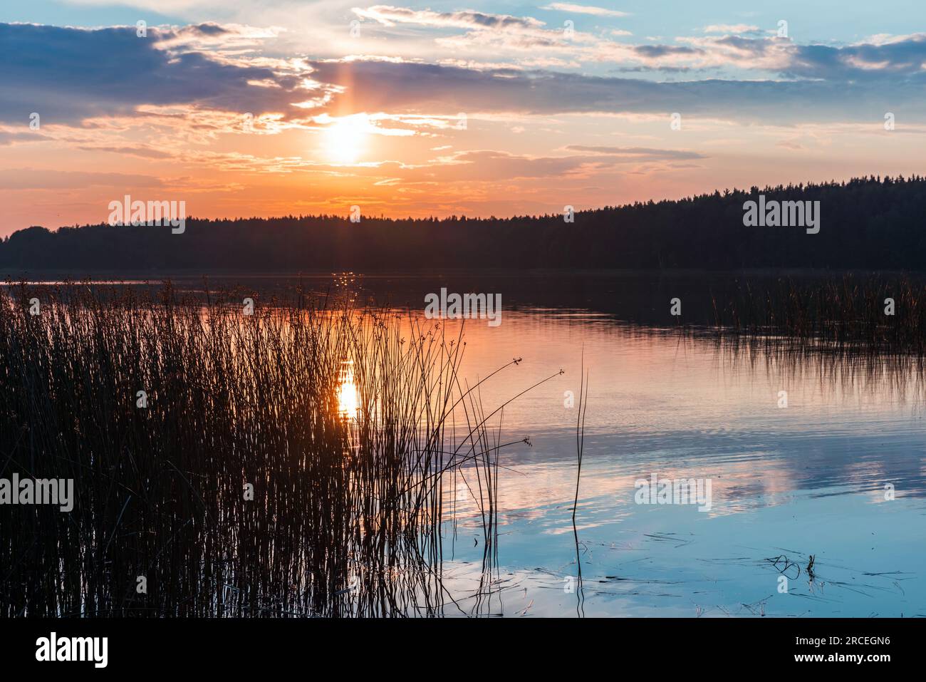 Dramatic landscape photo with colorful sunset clouds over still lake ...