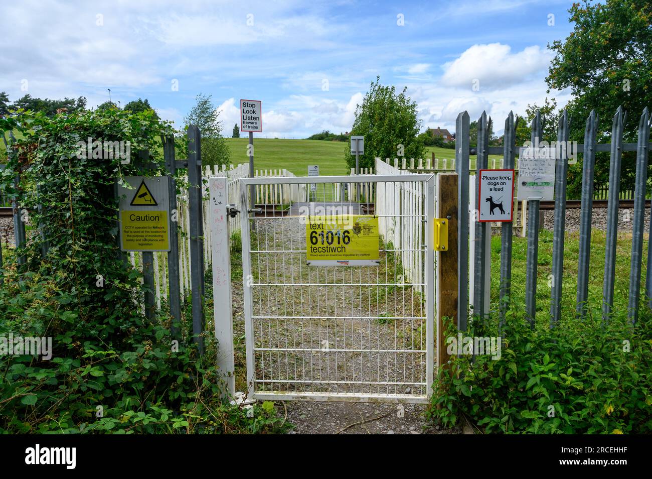 White gate on a pedestrian rail crossing on a UK rail line Stock Photo ...