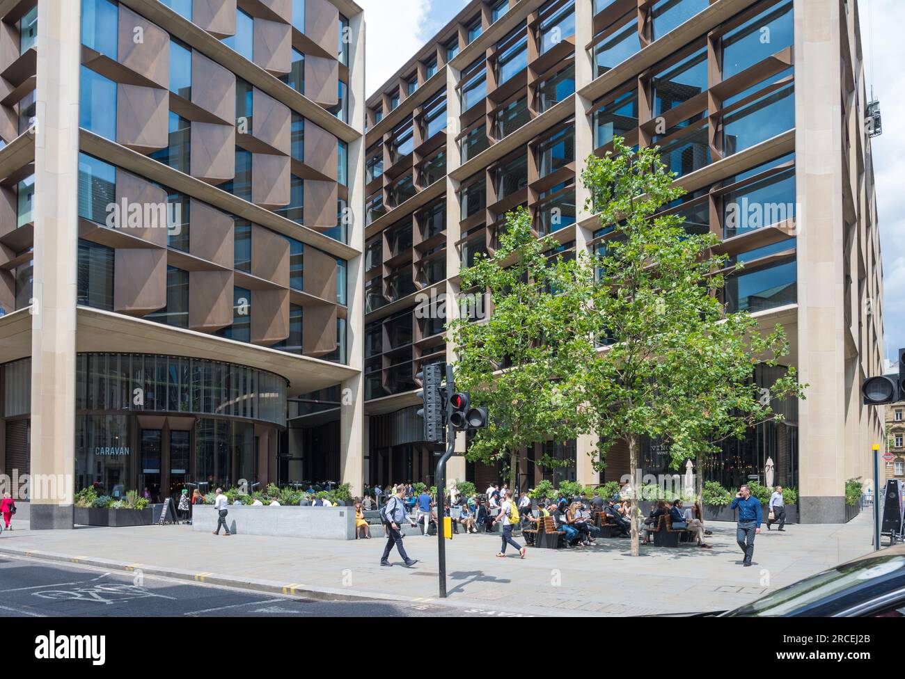 City workers at lunch time sit in small square at Bloomberg Arcade ...