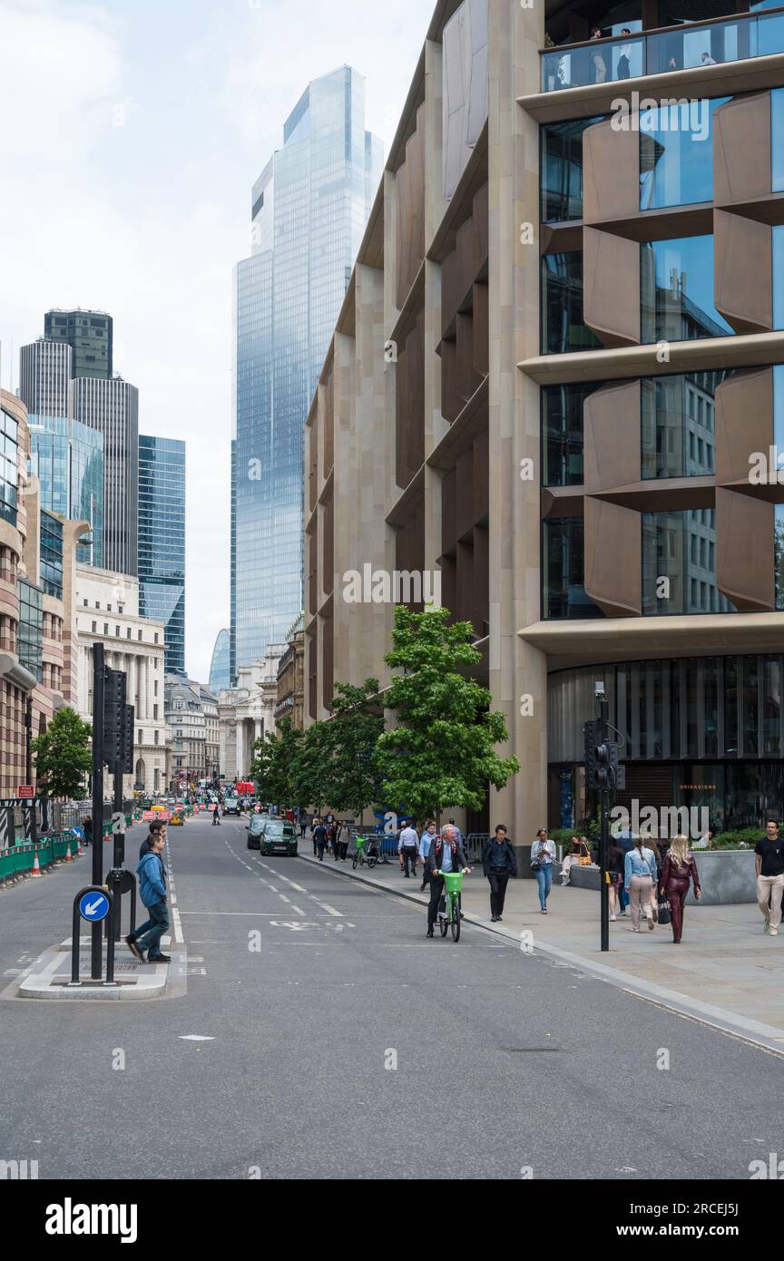 City workers at lunch time walk past Bloomberg office building in Queen ...