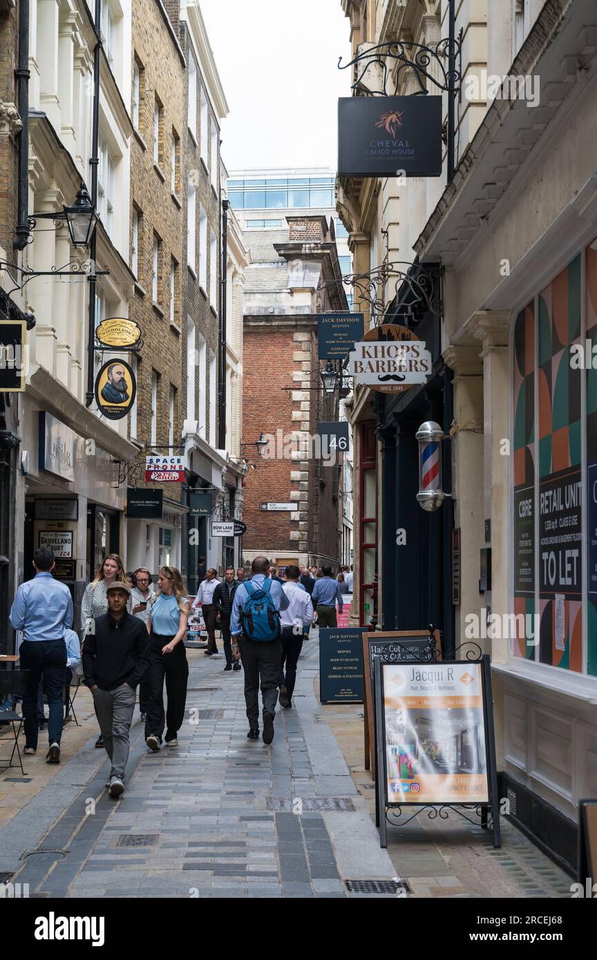 City of London workers walking in Bow Lane, a narrow lane lined with ...