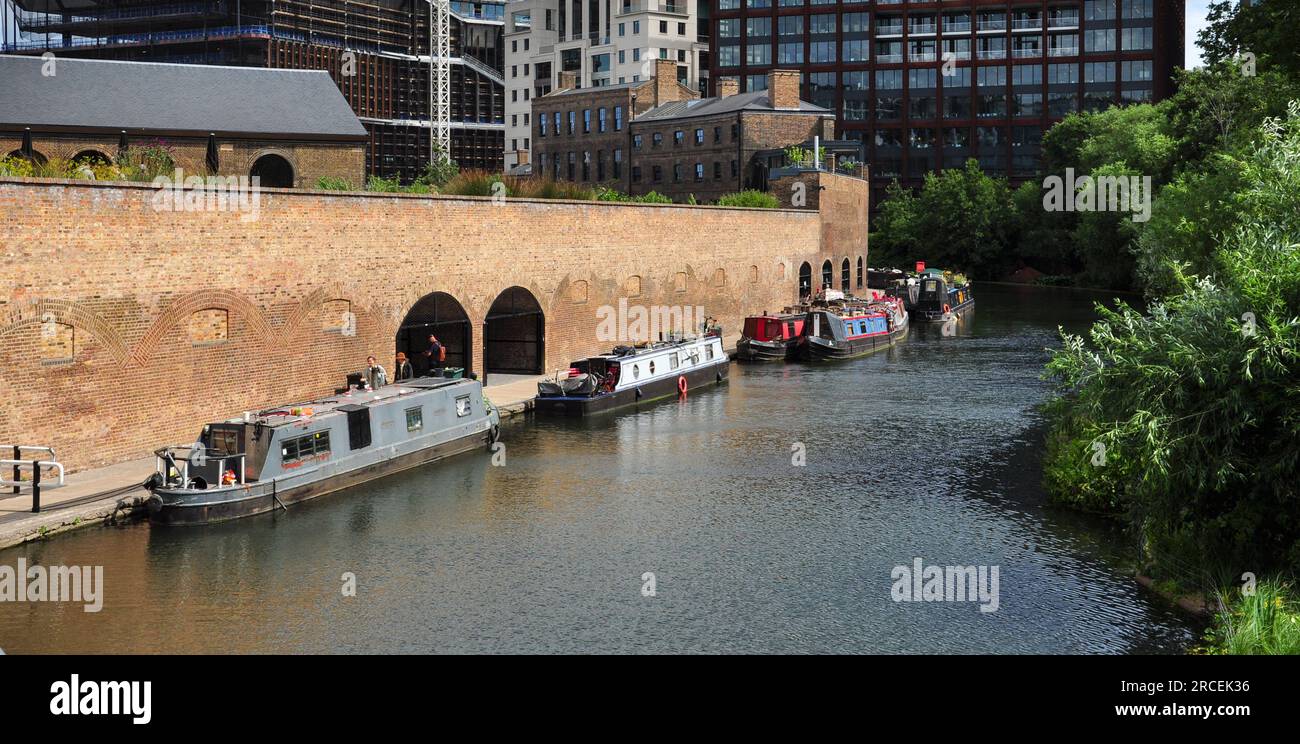Moored narrow boats by the old coal drops on the Regent's Canal at King ...