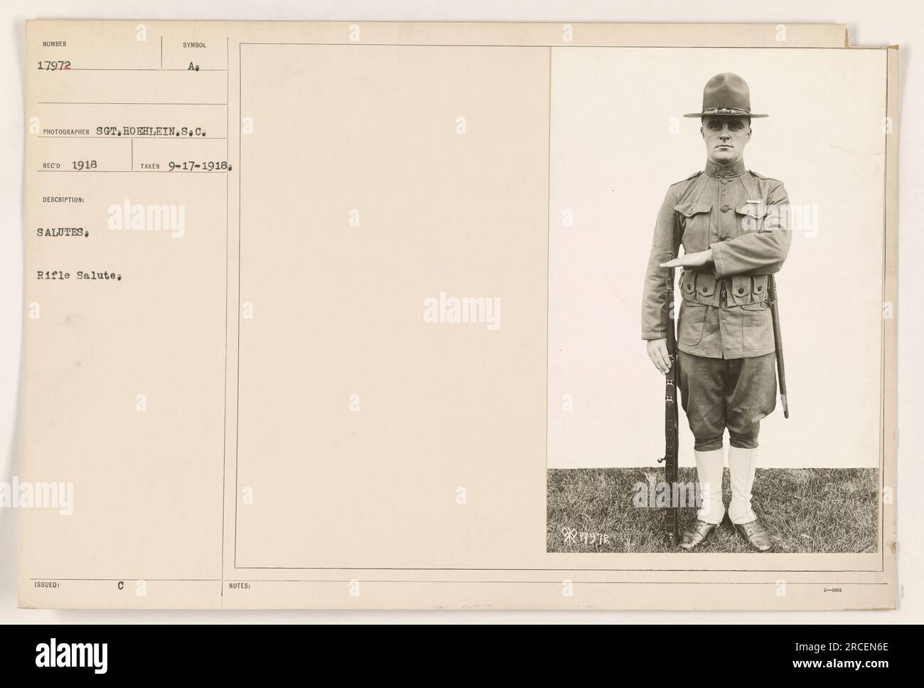Soldiers in military uniform performing a rifle salute during World War ...