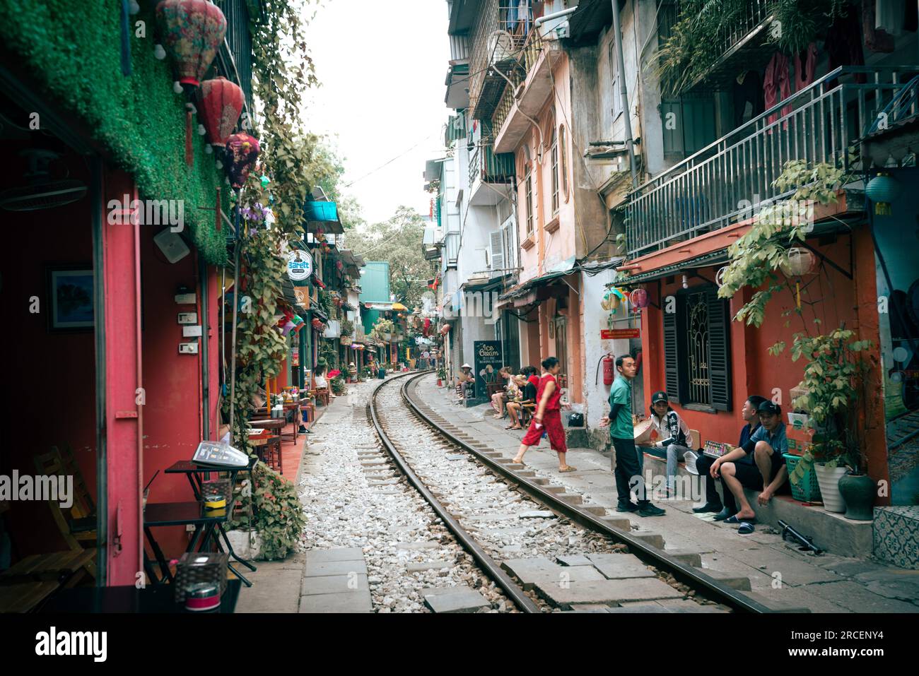 Watch the train pass by barely inches from the narrow houses and ...