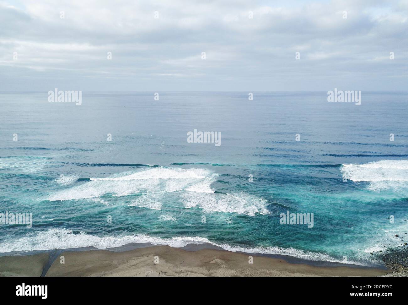 Aerial view of the beach with waves in the Atlantic ocean. Ribeira ...