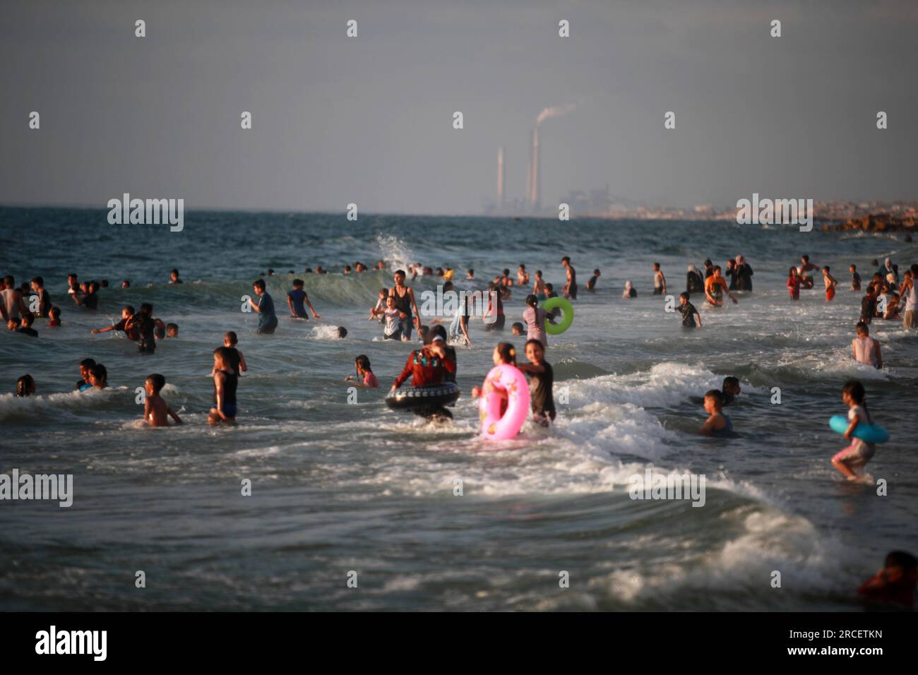 Palestinians gather at the beach in the Mediterranean Sea on the third ...